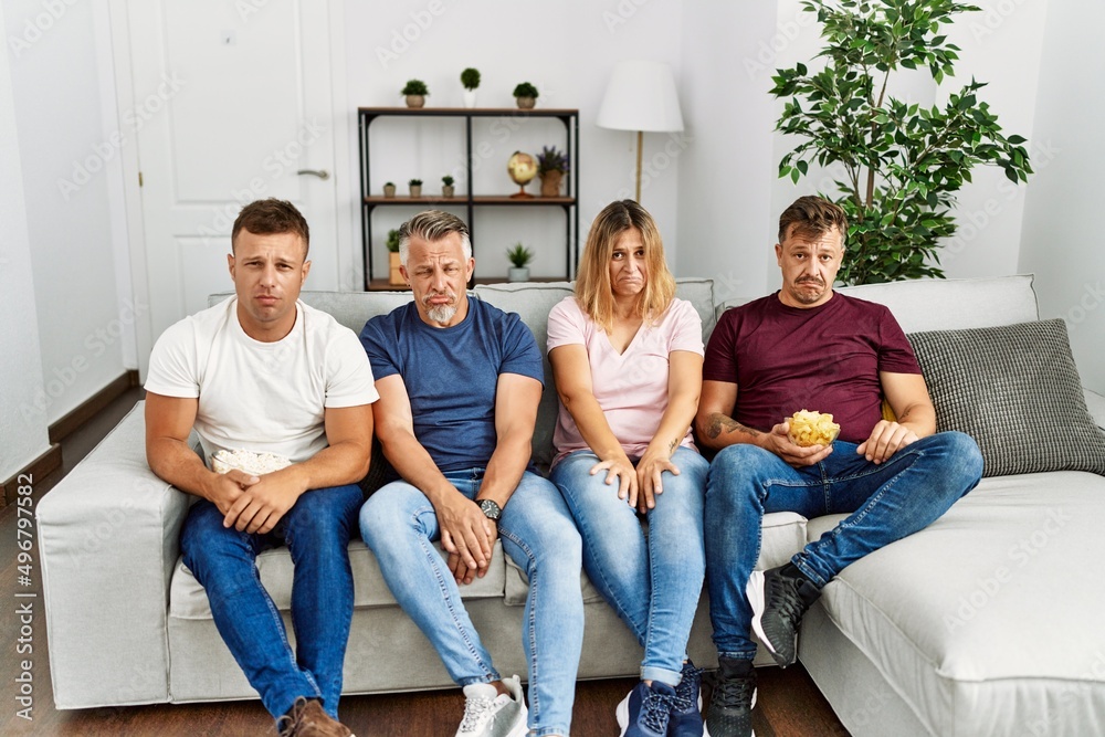 Group of middle age people sitting on the sofa at home depressed and ...