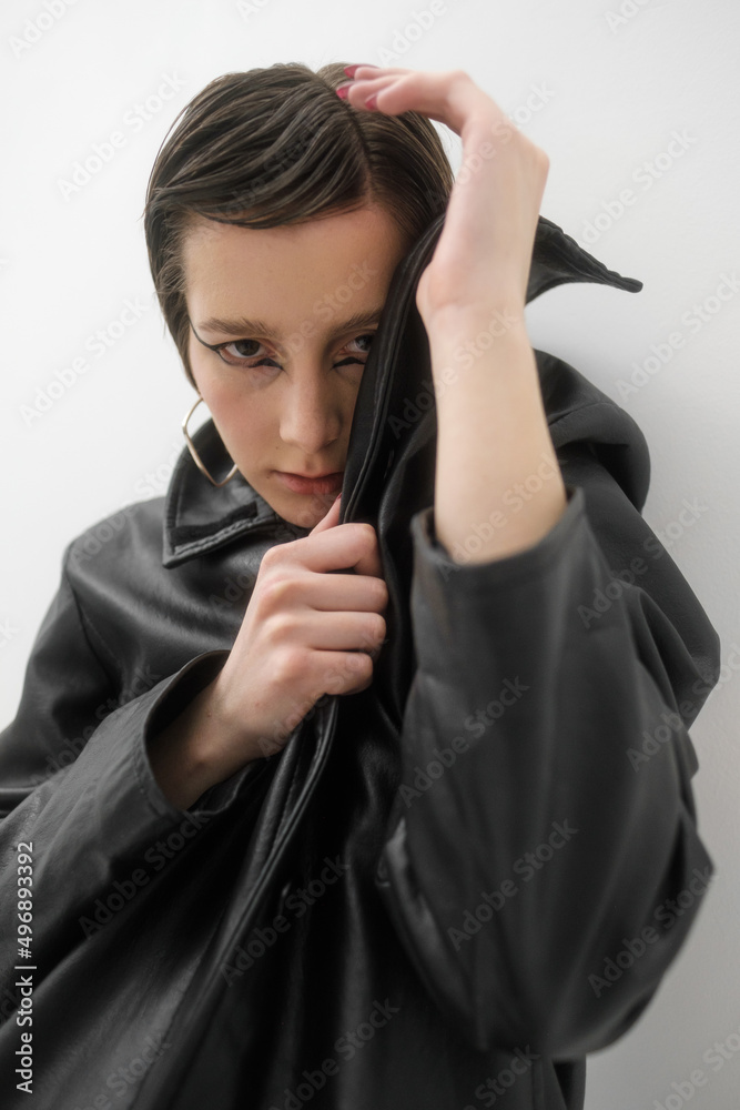 Fashion photo shoot in studio, on white background. Young beautiful ...