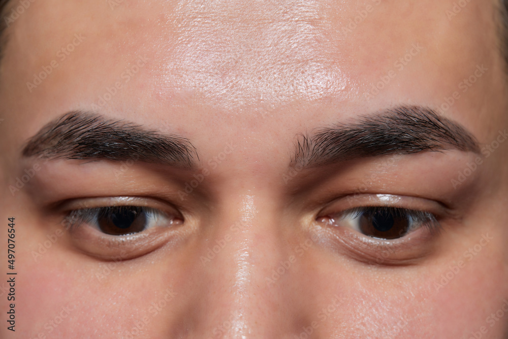 Professional barber doing threading procedure and correcting shape of ...