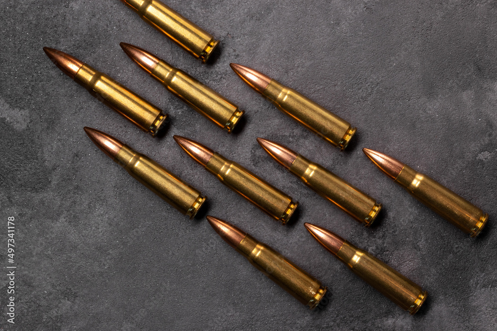 Bullets on gray background. Cartridges 7.62 caliber for Kalashnikov ...
