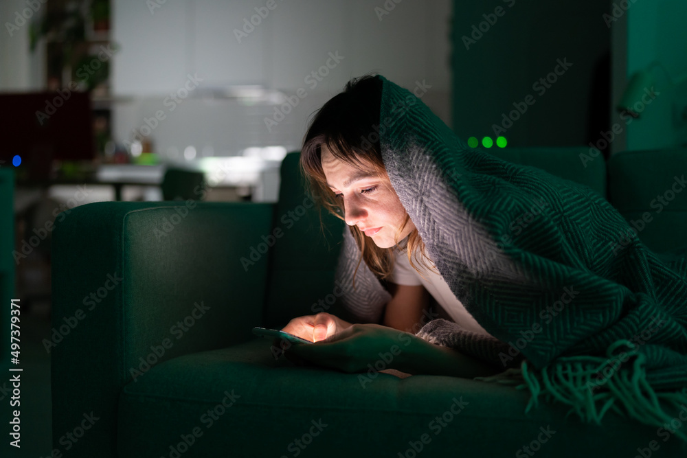 Exhausted woman surfing internet in dark room at night. Addicted young ...