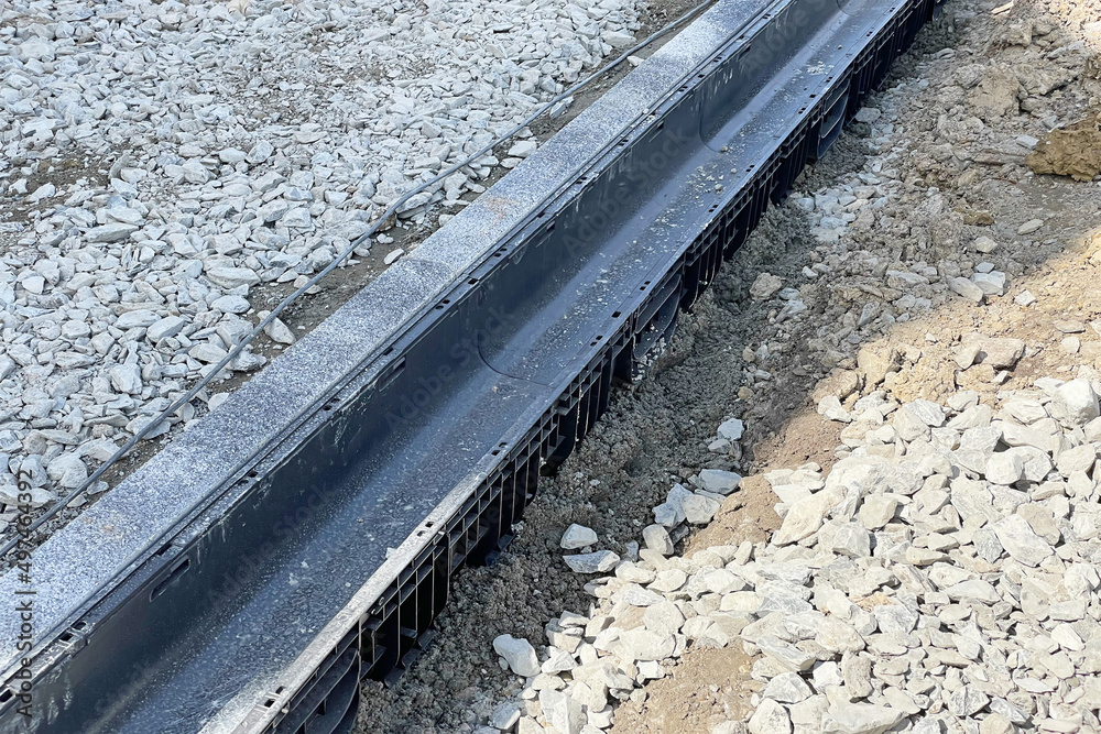 Installation and construction of laying a gutter to collect and drain ...