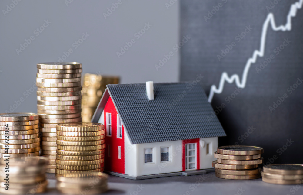 House with stacks of money and a rising curve symbolizing rising real ...
