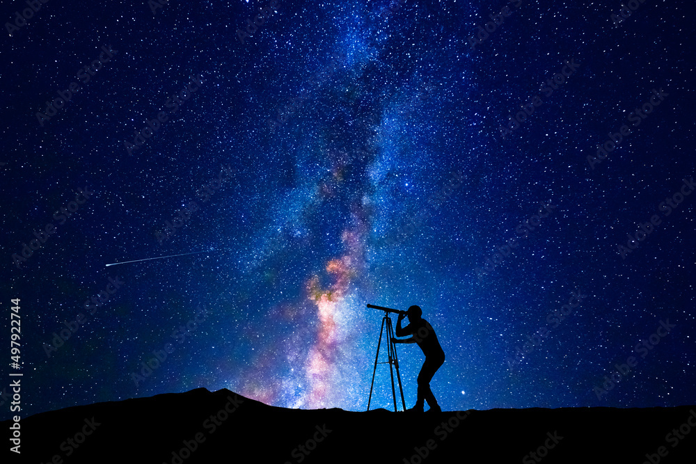 Man looking at the stars through a telescope Stock Photo | Adobe Stock