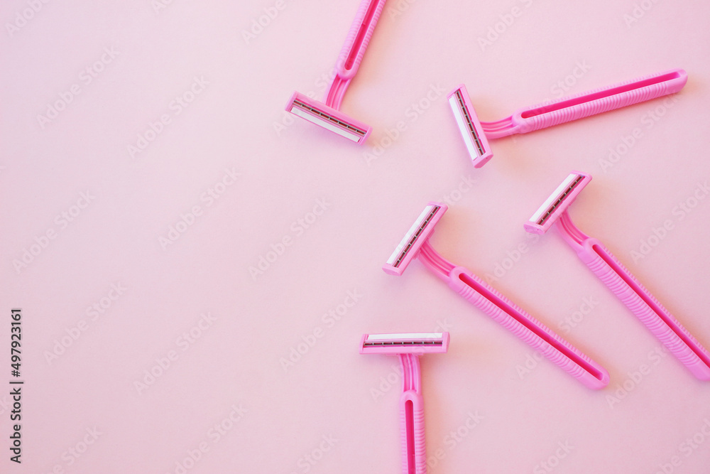 Disposable female razor on a pink background. A tool to remove hair ...