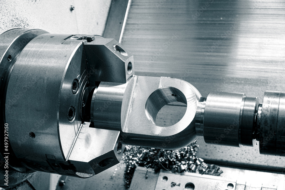 Photo Stock Solid steel metal workpieces mounted on spindle chucks of high-precision CNC ...