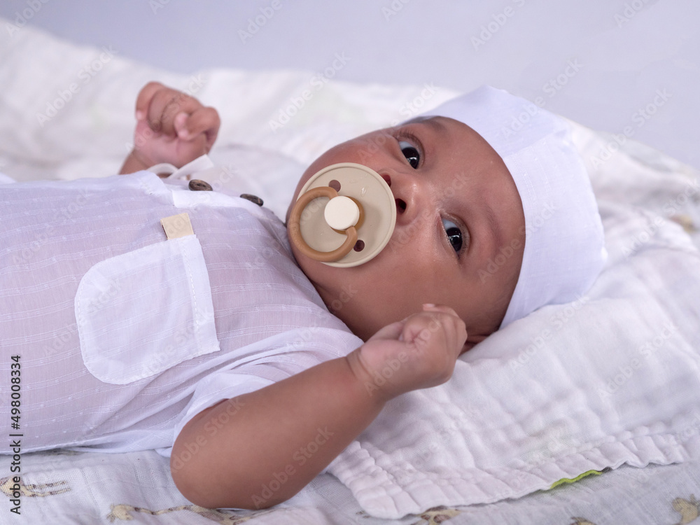 Adorable little Muslim baby boy wearing white cotton traditonal Islamic ...