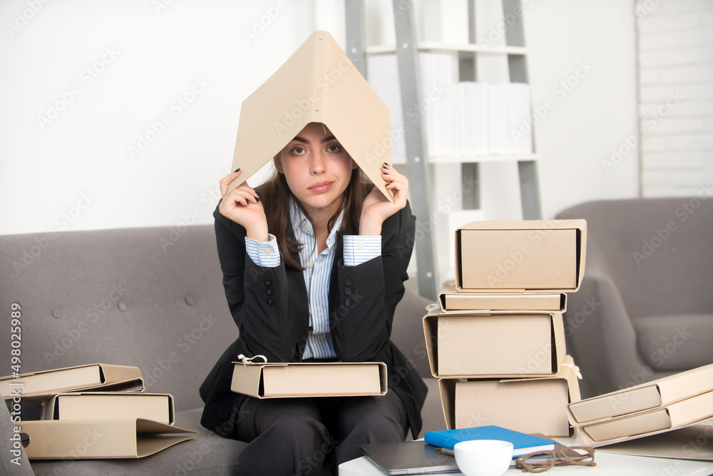 Sad busy secretary with many folders of documents, stressed overworked ...