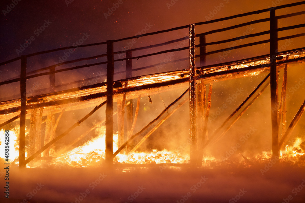 Burning wooden bridge in a raging flame close-up. Bridge on fire at ...
