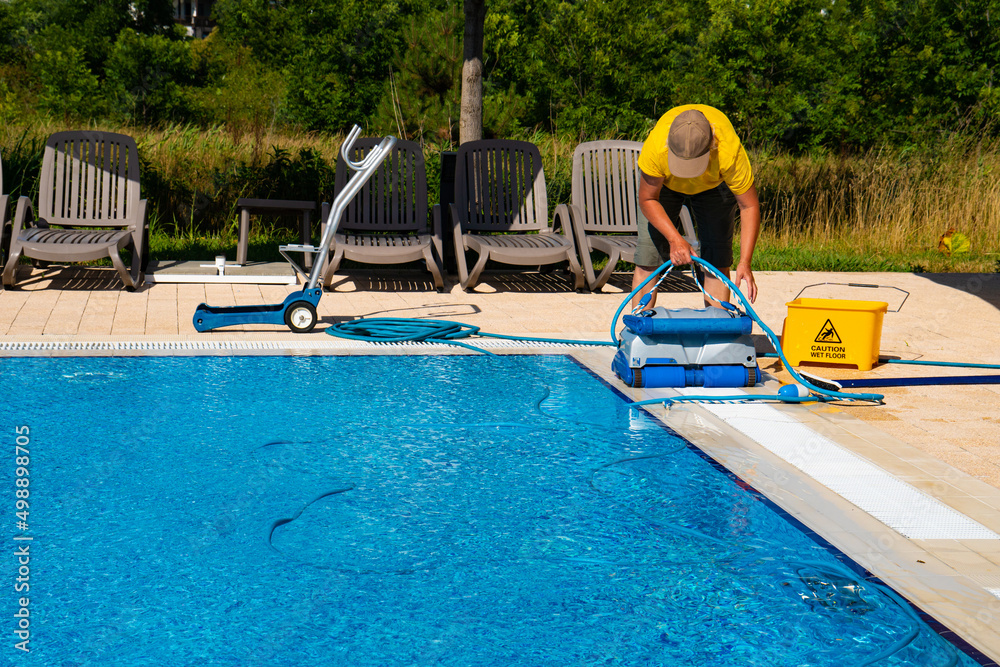 The cleaner turns on an automatic cleaning robot to clean the pool ...