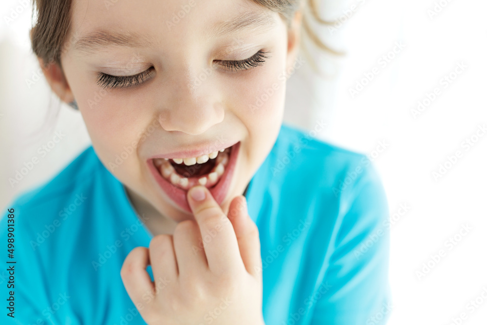 The kid lost a tooth. Baby without a tooth. Portrait of a little girl ...