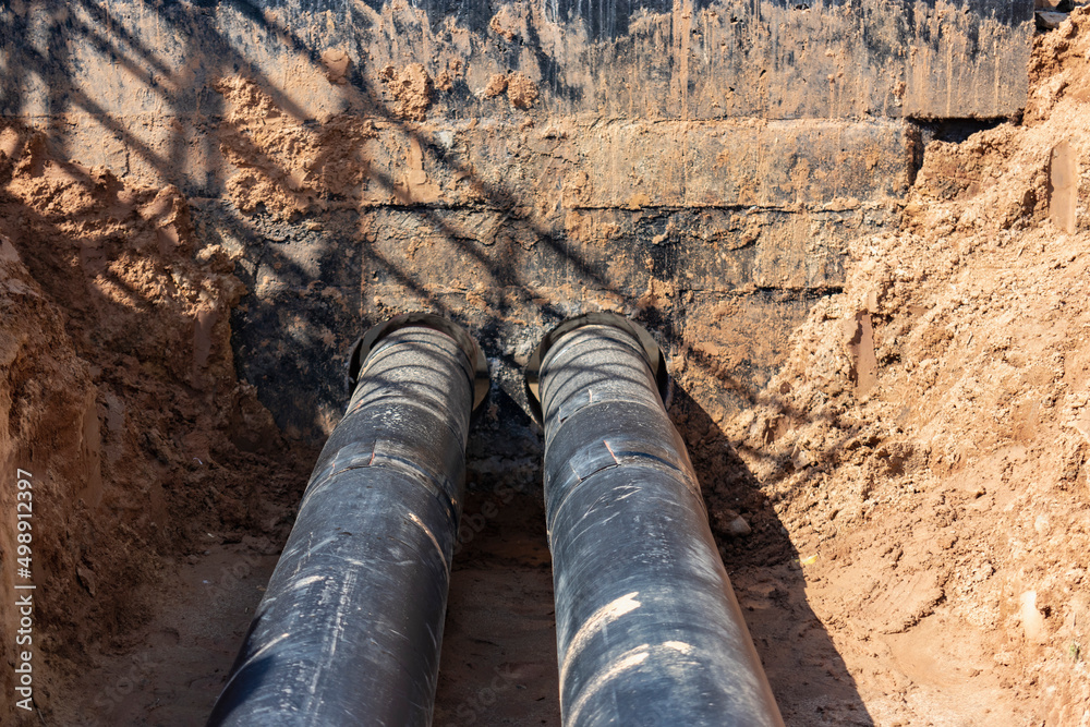 Laying of underground pipes in concrete chamber. Installation of water ...