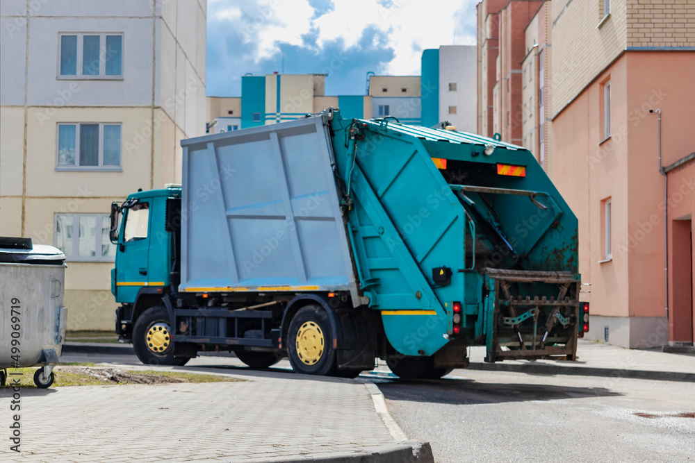 An automobile garbage truck collects garbage in residential areas of a ...