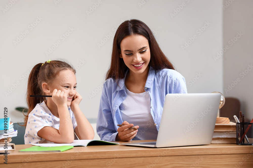 Cute girl studying with tutor at home Stock Photo | Adobe Stock