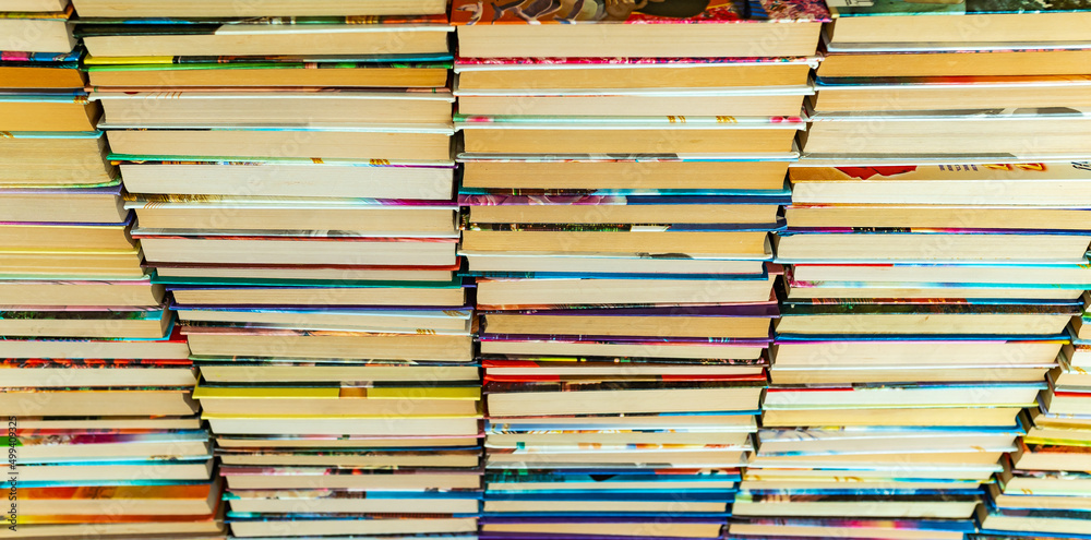Endless wall of old books stack background. Colorful educational used ...