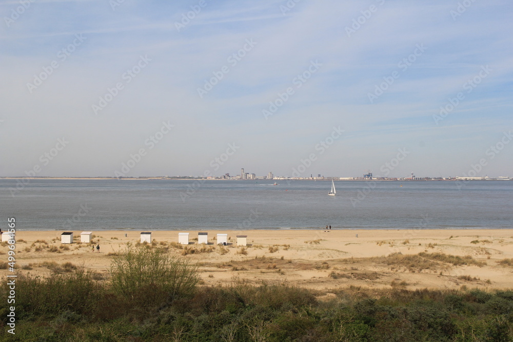 a dutch coast landscape in breskens with a sand beach with beach houses ...