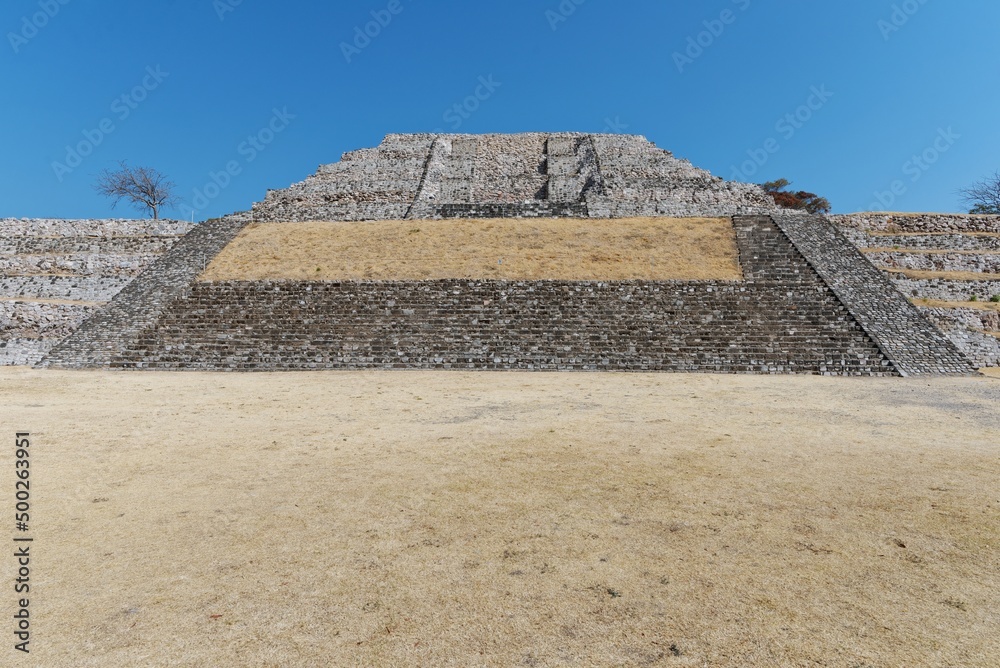 Ancient step pyramids on top of a mountain. Cleared meadows with grass ...