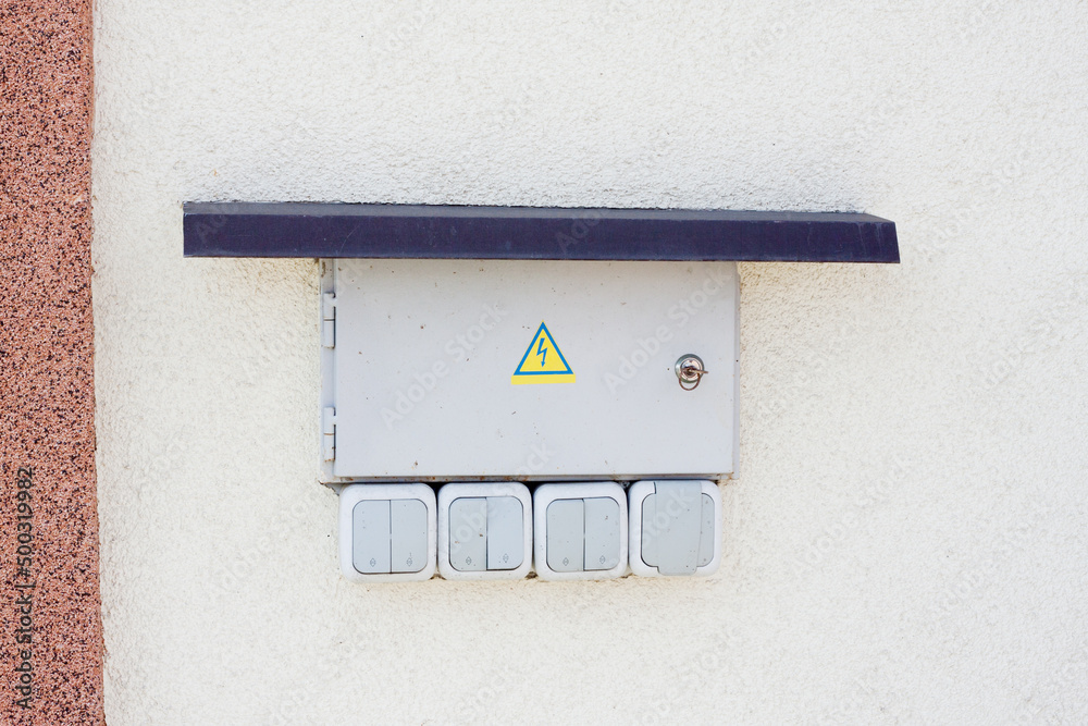External electrical box with lock is placed on wall of house from the ...