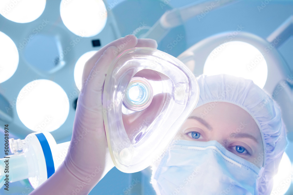Anesthesiologist holding oxygen mask for induction in operating room ...