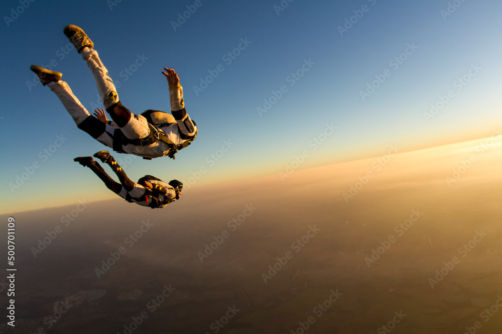 Skydiving couple in freefall at sunset, togetherness concept Stock ...