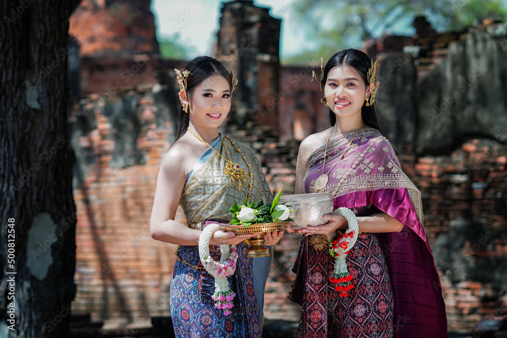 woman in clothing. Thai girls splashing water during festival Songkran ...