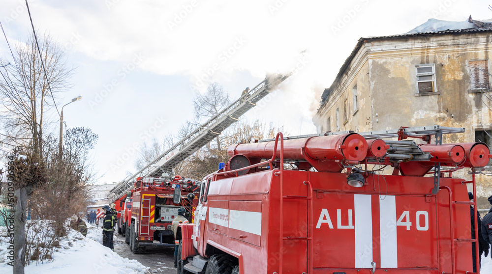 Firefighter works on boom of fire engine. Fireman on sky background ...