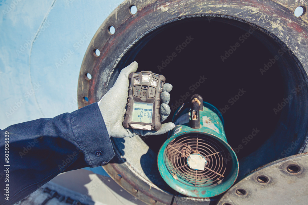 Worker hand holding gas detector inspection safety gas testing at front ...