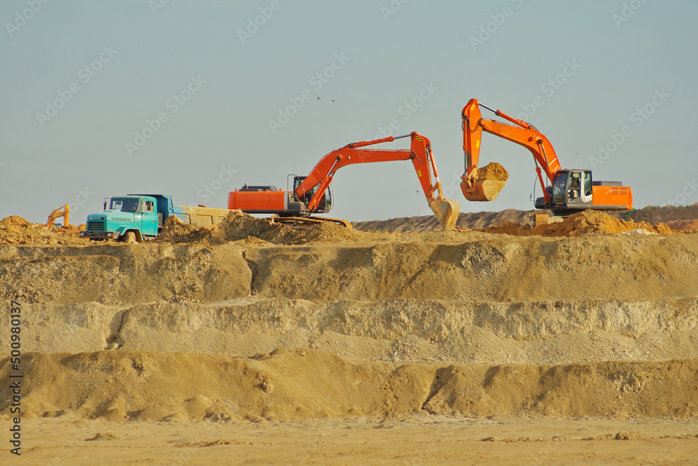 Excavation and loading onto dump trucks with excavators. The work of ...