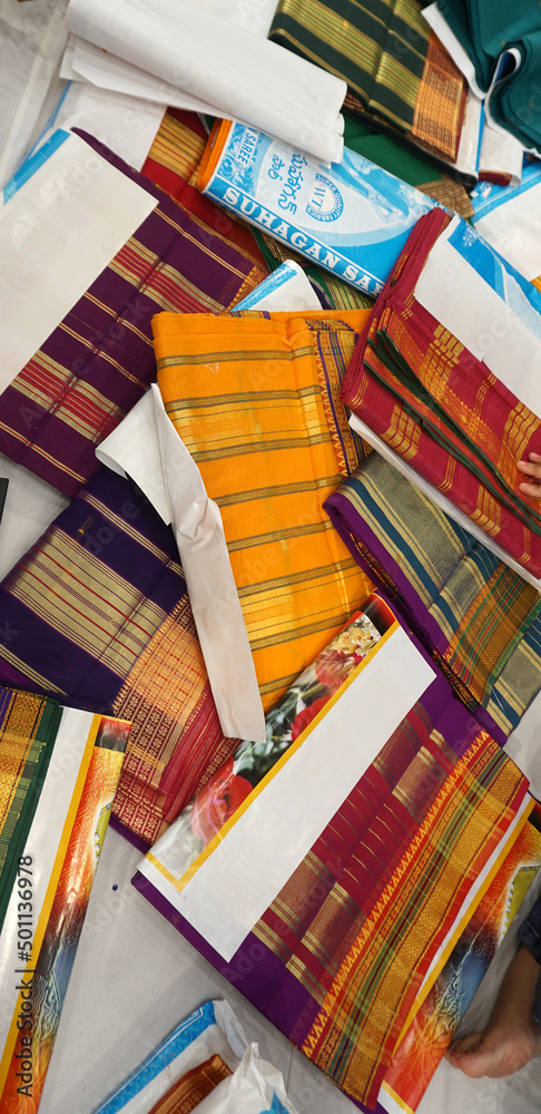 Colorful sarees or saris are arrange on racks and display in a retail ...