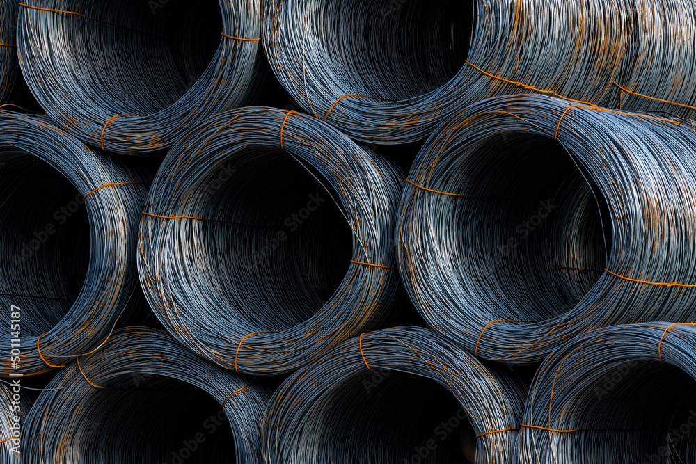 Stack of round steel wire coils at a freight station ready for ...