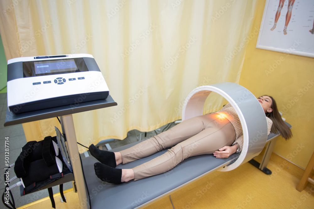 Magnet therapy system. Patient on a treatment bed with Magnetic Field ...