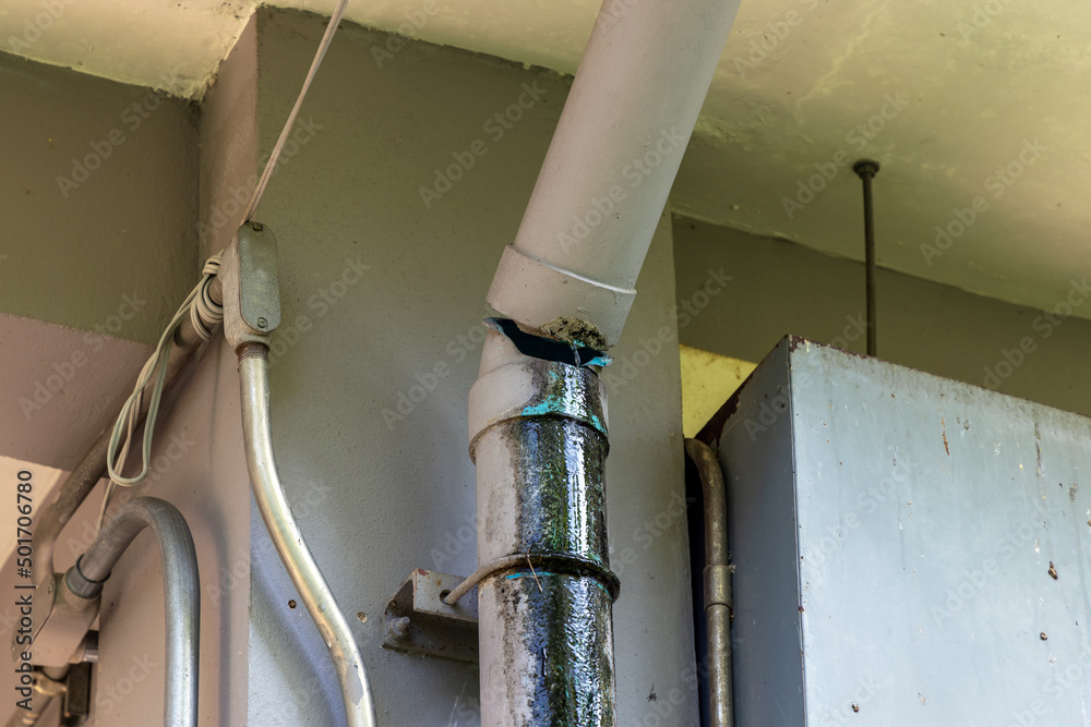 Water leaking from pipe line broken in building. Water drop from drain ...