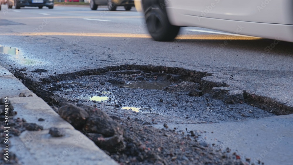Vehicles Driving Over Large Erosion Damage Hole in City Street Asphalt ...