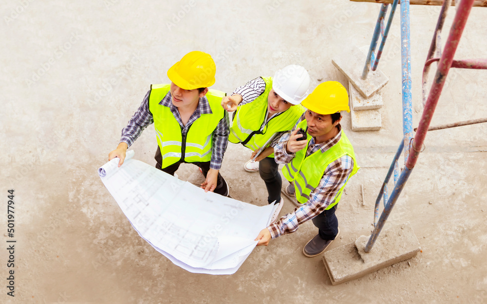 Top view Female lead architect consulted with two male workers standing ...