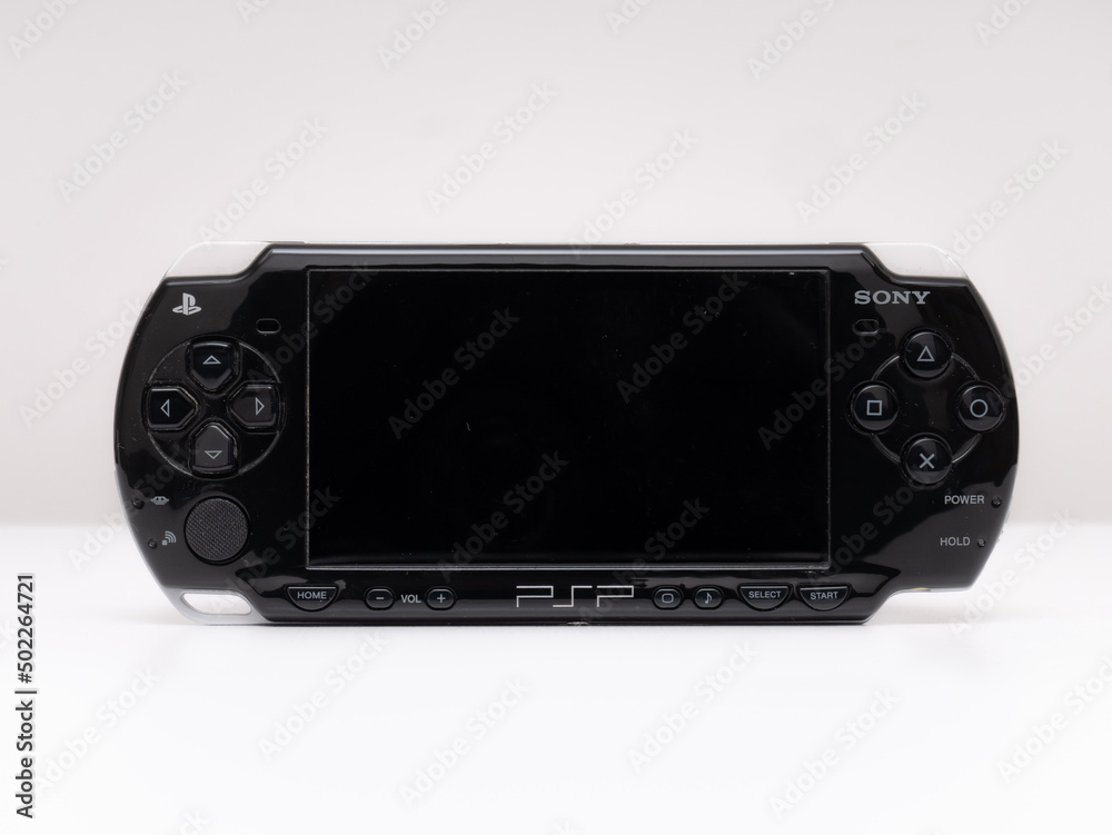 Front view of the famous Sony PSP (Playstation Portable) video game console in black on a white ...