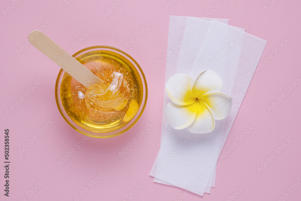 Liquid yellow sugar paste, wooden spatula, depilatory strips and flower ...