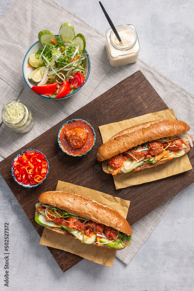 Banh Mi - Vietnamese sandwich with sausage, pork, lettuce, tomato and ...