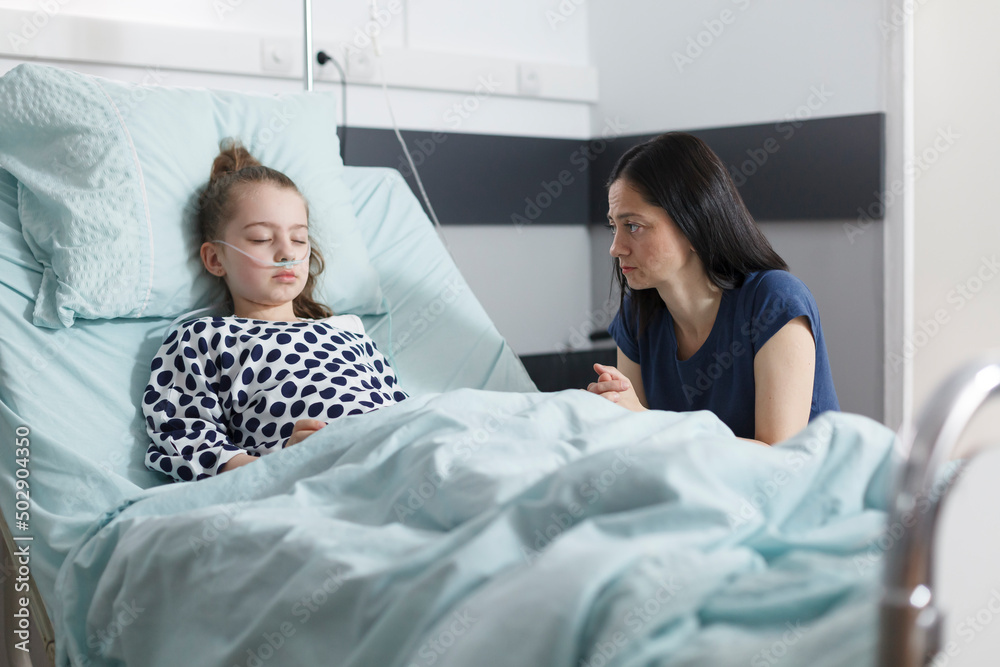 Photo Stock Thoughtful worried sad woman looking at sleeping ill ...