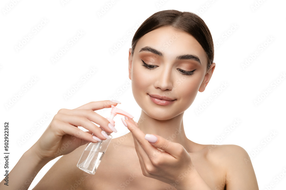 Tender young woman with perfect skin applying face lotion isolated over ...