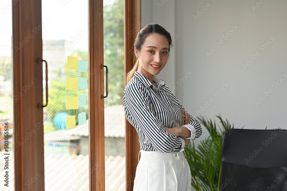An Indian confident beautiful female looking at the camera with a ...