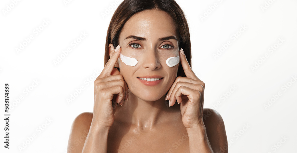 Charming, pretty, old woman touching her perfect soft face skin with ...