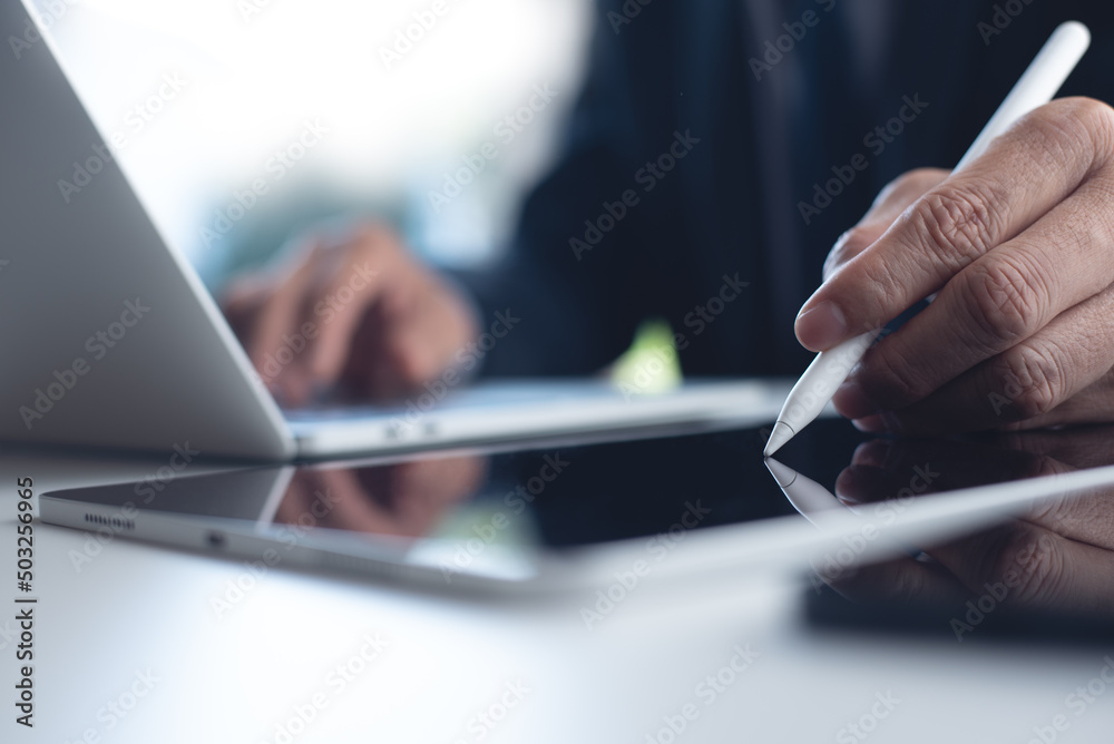 Closeup of businessman using stylus pen signing business contract on ...