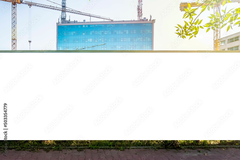 Blank white advertising banner on the fence of construction site with ...