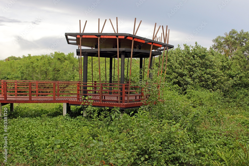 Raised pedestrian walkway leads to a hut or pagoda built for shade and ...
