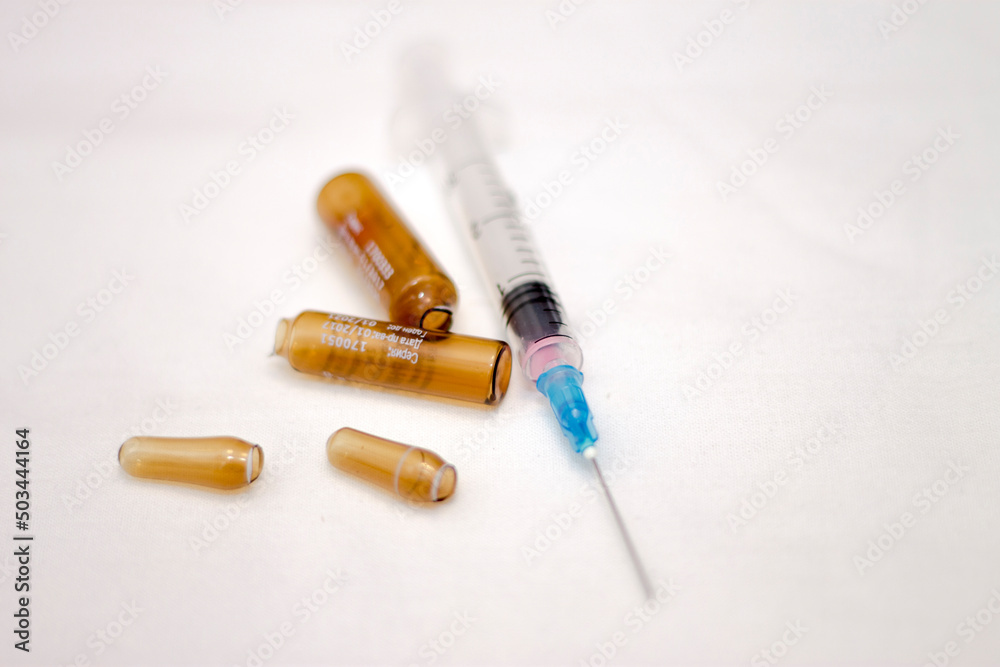 Empty medical ampoules infusion and used syringe after vaccination ...