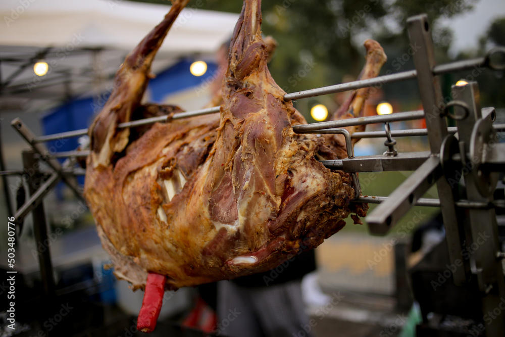 lamb on a spit. Whole lambs baked on a spit, direct on fire outdoor ...