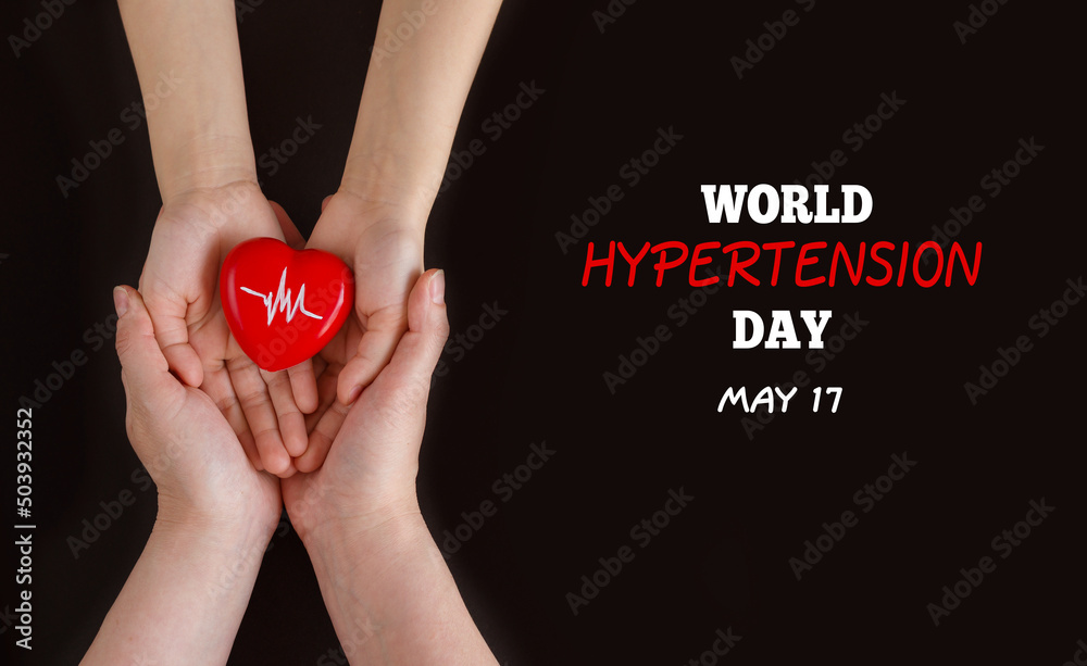 World Hypertension Day. Mom and baby holding red heart with heartbeat ...