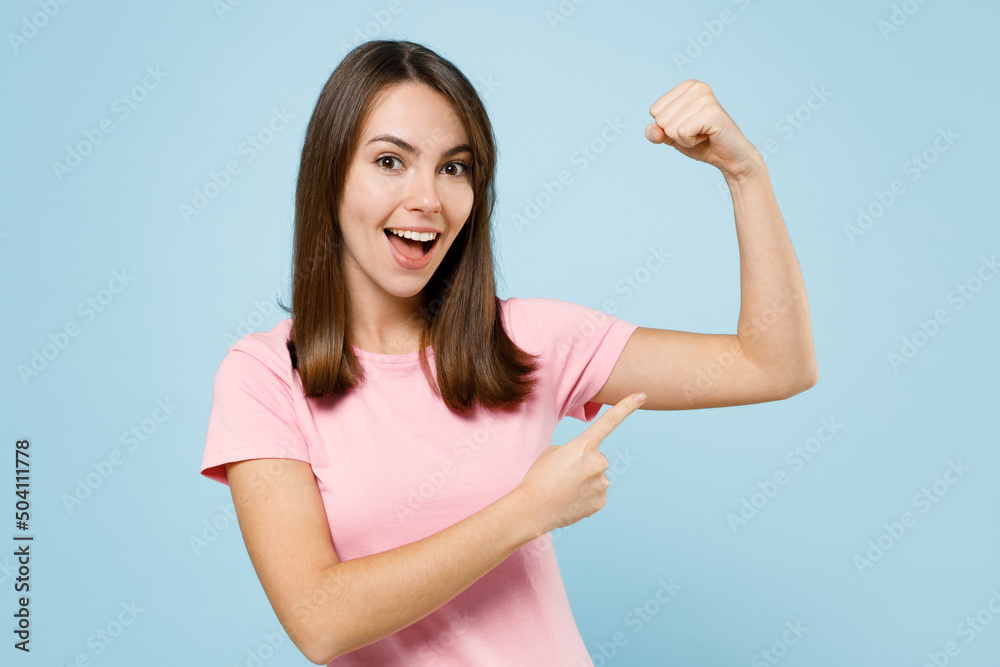 Young happy woman 20s in pink t-shirt showing point index finger on ...
