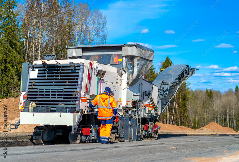 Road milling machine, scraper removes the old layer of asphalt from the ...