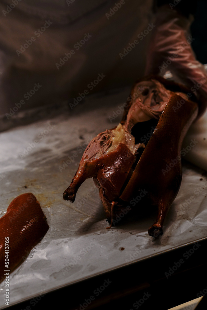 Chinese cook prepares Peking Roast Duck. Peking Duck is a famous duck ...